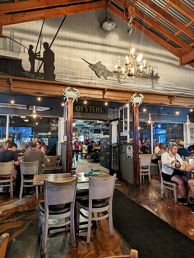 Fishing silhouettes watch over diners from the wall mural, while crab decorations stand guard at the "OYSTERS" entrance &ndash; subtle maritime theater.