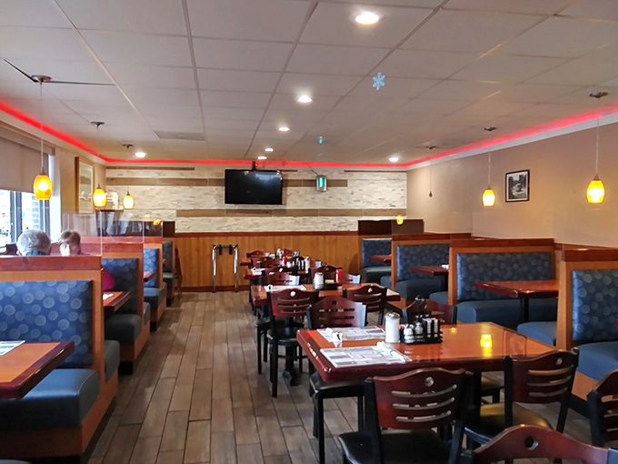 The dining room &ndash; where red accent lighting and comfortable booths create that perfect "everybody knows your name" atmosphere without trying too hard. 