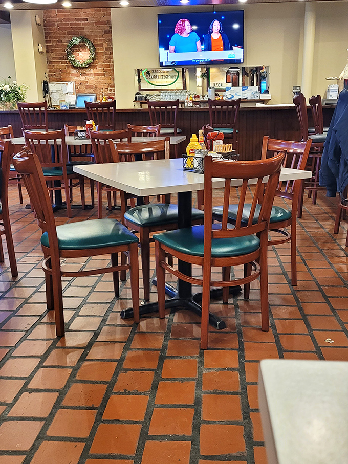 The dining room balances nostalgia with comfort—terra cotta floors, wooden chairs, and enough space between tables to keep your conversation about last night's game private.