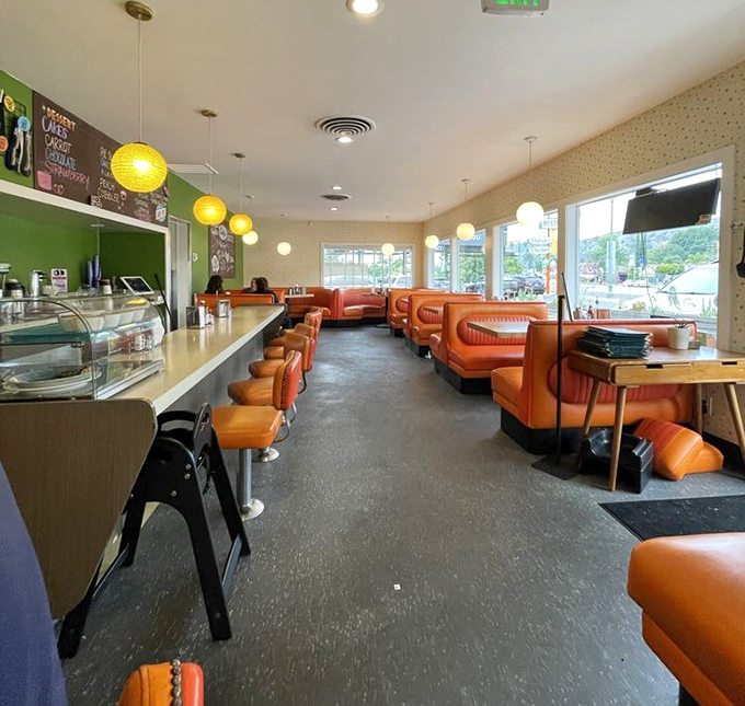 The diner's empty moment before the breakfast rush&mdash;like seeing a Broadway stage before the show. Those orange booths are ready for their starring role.