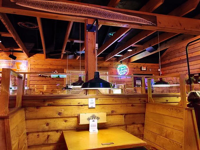 High-backed wooden booths create little kingdoms where conversation flows as freely as the sweet tea.