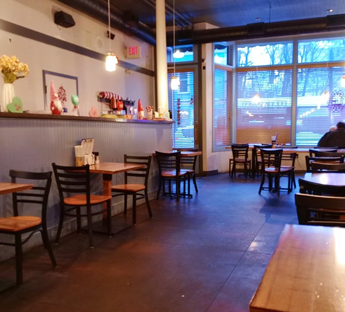 Simple wooden tables and chairs create an unpretentious dining space where the food, not the furniture, rightfully takes center stage.