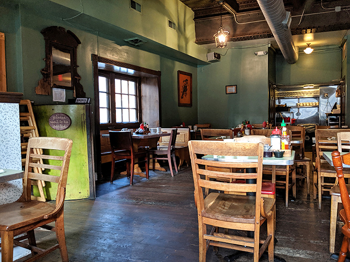 The dining room's mint green walls and wooden chairs create an atmosphere that says, "Stay awhile, we've got stories to tell."
