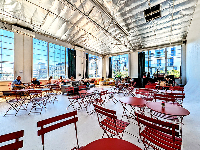 Sunlight floods through warehouse-style windows, turning an ordinary coffee break into what feels like a European holiday.