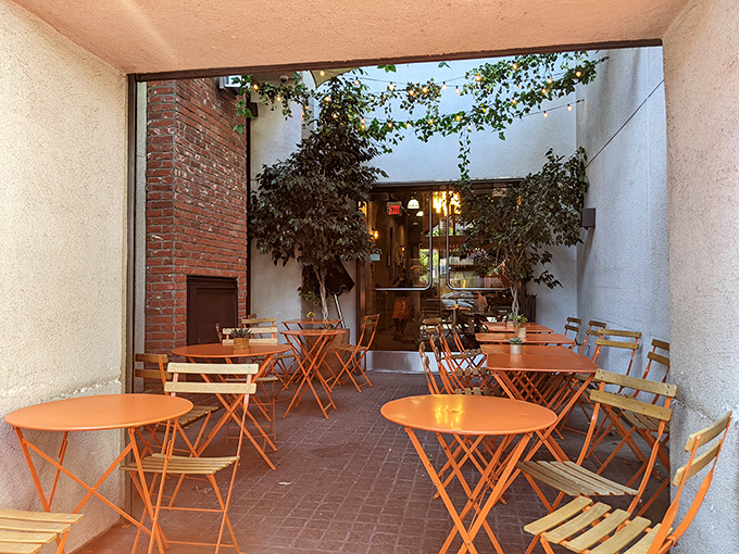 A hidden courtyard with cheerful orange tables where Parisian caf&eacute; culture meets California sunshine. Your laptop can wait.