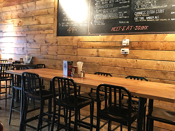The communal table against that gorgeous wood wall isn't just furniture—it's an invitation to linger over good food and even better conversation.