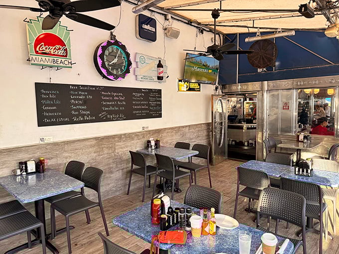 The outdoor dining area offers a front-row seat to Miami Beach's parade of humanity, with Coca-Cola signs nodding to simpler times. 