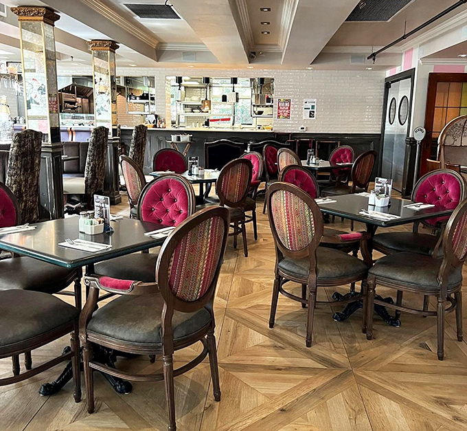 Burgundy chairs and polished tables create an atmosphere where every meal feels like a celebration.