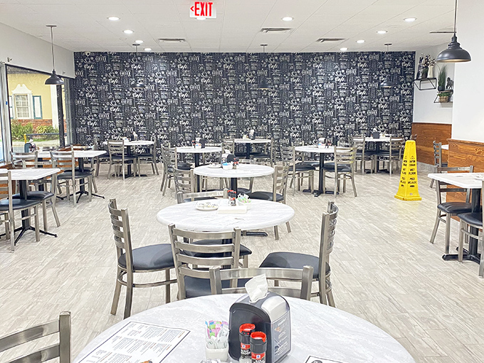 The dining room has that perfect "fancy enough for Sunday brunch but comfortable enough for Tuesday blues" vibe. That feature wall practically whispers "stay awhile."