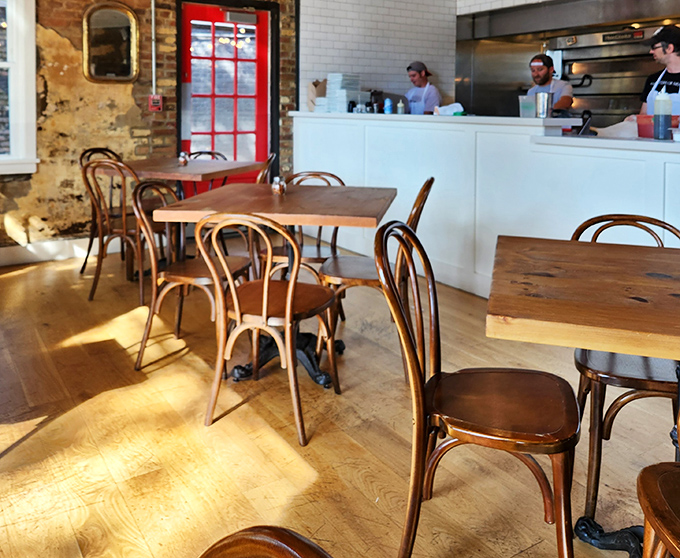 Bentwood chairs and rustic tables create the perfect backdrop for serious pizza conversations.