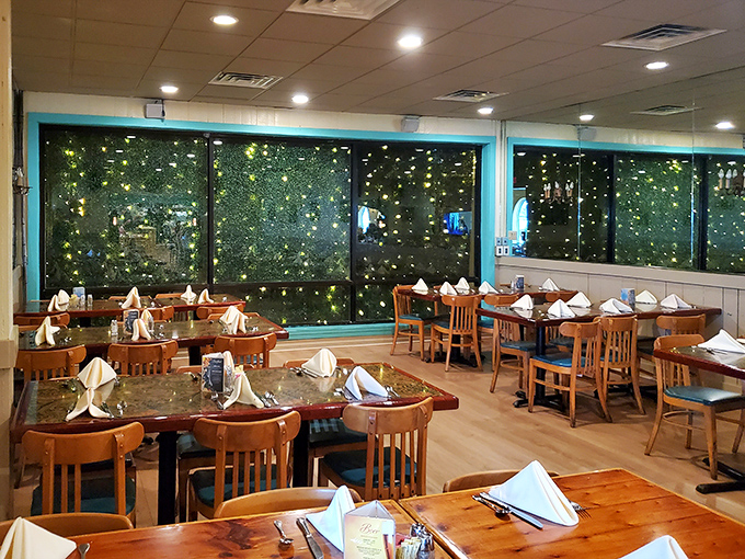 Evening transforms the dining area into a magical space where twinkling lights outside the windows create the illusion of dining among the stars.