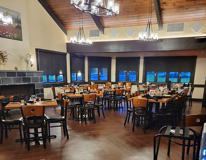 High ceilings, elegant lighting, and thoughtfully arranged tables create a dining room that balances rustic charm with sophisticated comfort—like a country lodge with city manners.