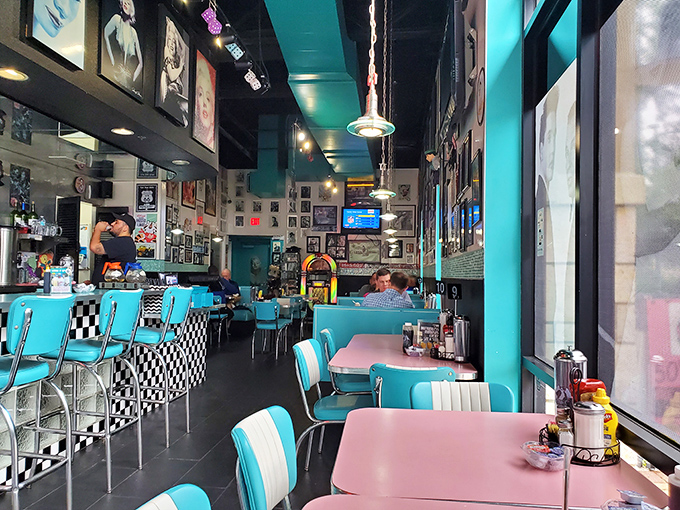 The dining area feels like stepping into a 1950s postcard, where turquoise dreams and checkered patterns set the stage for culinary nostalgia.