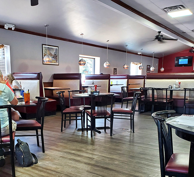 Modern pendant lighting illuminates comfortable booths where countless coffee cups have been refilled and life stories exchanged.