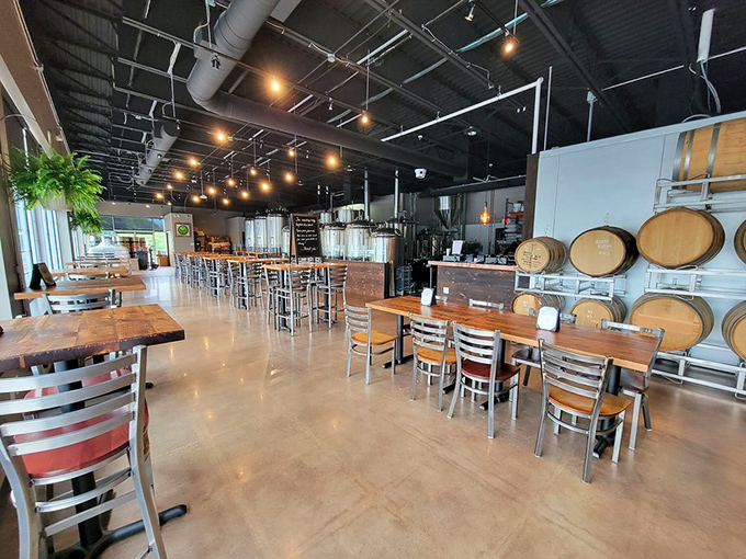 Where industrial meets inviting&mdash;wooden tables, barrel accents, and brewing equipment create a space that says "stay awhile, friend."