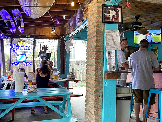 Where neon beer signs meet family photos, creating the perfect backdrop for conversations that flow as easily as the draft beer.
