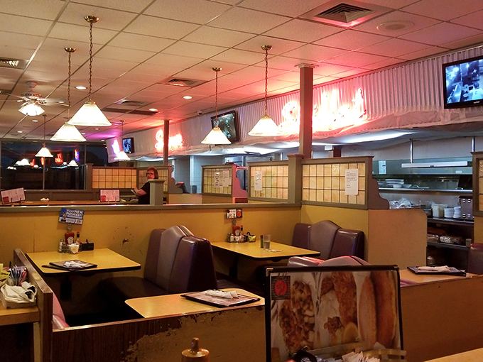 Cozy booths bathed in warm lighting create the perfect backdrop for both first dates and "we've been married 50 years" celebrations.