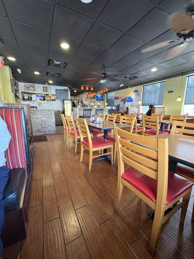 The dining room's warm wood tones and yellow walls create an atmosphere where strangers become neighbors. A democratic space where everyone speaks the language of good food.