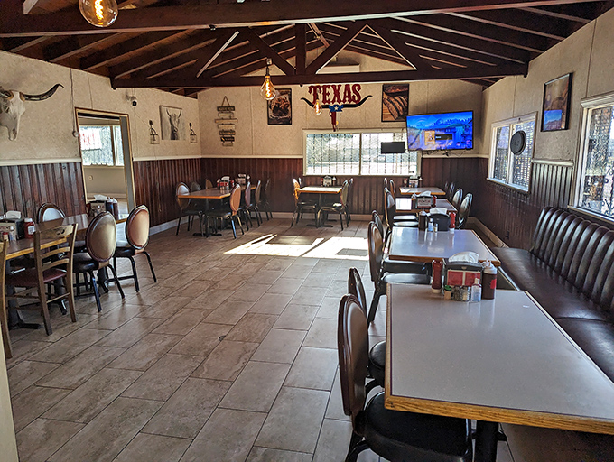The dining room's warm wood tones and checkered tablecloths make every meal feel like a family gathering. 