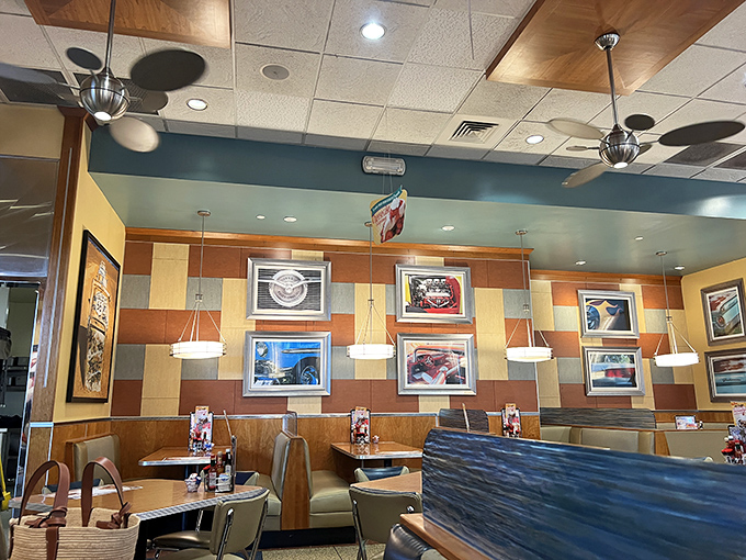 The dining area's warm color palette and classic car photos create the perfect backdrop for the serious business of comfort food consumption.