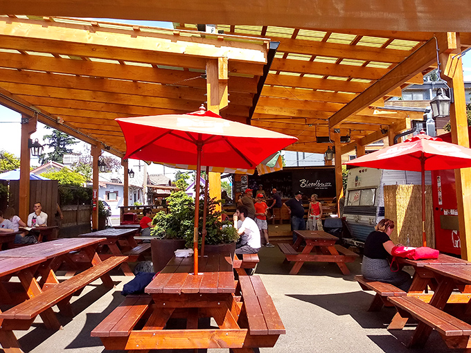 On sunny Portland days, this covered dining area becomes barbecue paradise. Red umbrellas add pops of color to match the sauce stains on your napkins.