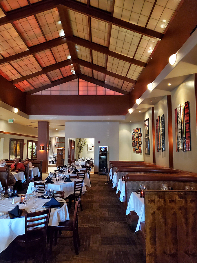 Soaring ceilings and warm lighting create an atmosphere where every meal feels like a special occasion worth celebrating.