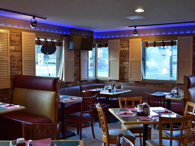 Corner booths: the VIP section of diner real estate, where brick walls and blue lighting create the perfect backdrop for serious breakfast decisions.