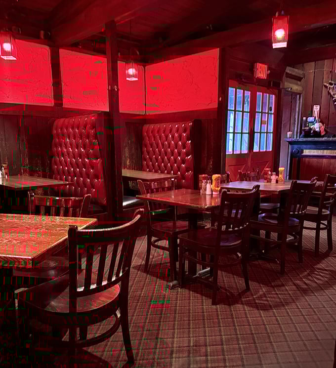 Red tufted booths and warm lighting create dining nooks that feel both private and convivial &ndash; the perfect setting for intense food focus.