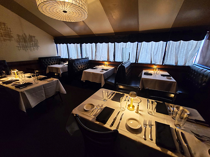 The dining room whispers of countless celebrations and first dates, where white tablecloths and leather booths set the stage for memorable meals.