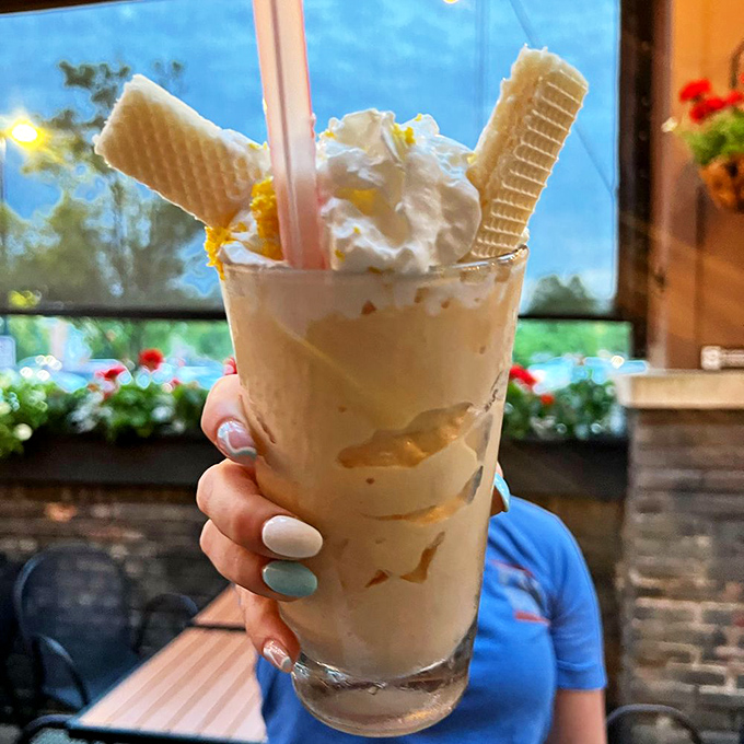 The Dreamsicle Shake: childhood nostalgia in a glass, with wafers standing at attention like delicious soldiers guarding liquid treasure.
