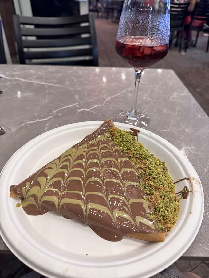 This chocolate-drizzled crepe with pistachios isn't just dessert, it's edible artwork worthy of its own exhibition.