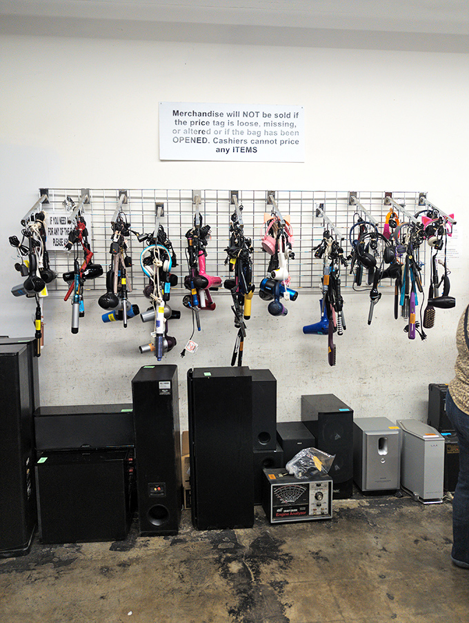 Electronic odds and ends alongside hair dryers and speakers. The sign above says it all&mdash;merchandise rules apply even in this wonderland of gadgetry.