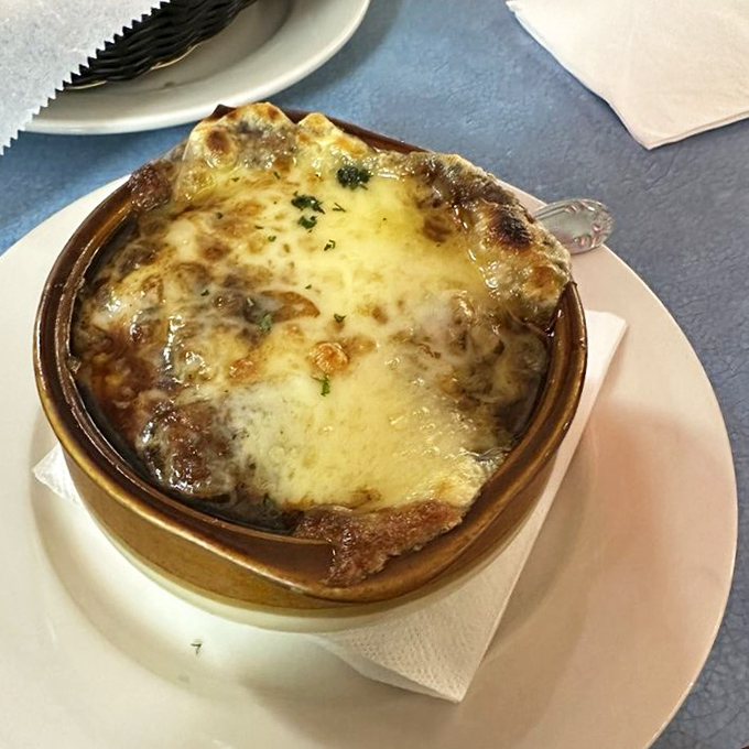 French onion soup with a cheese roof so perfectly browned it deserves its own architectural award.