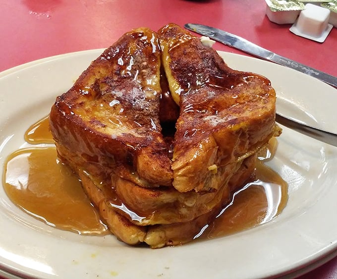 French toast that's achieved that mythical balance between crispy exterior and custardy interior. The maple syrup river adds the perfect finishing touch.