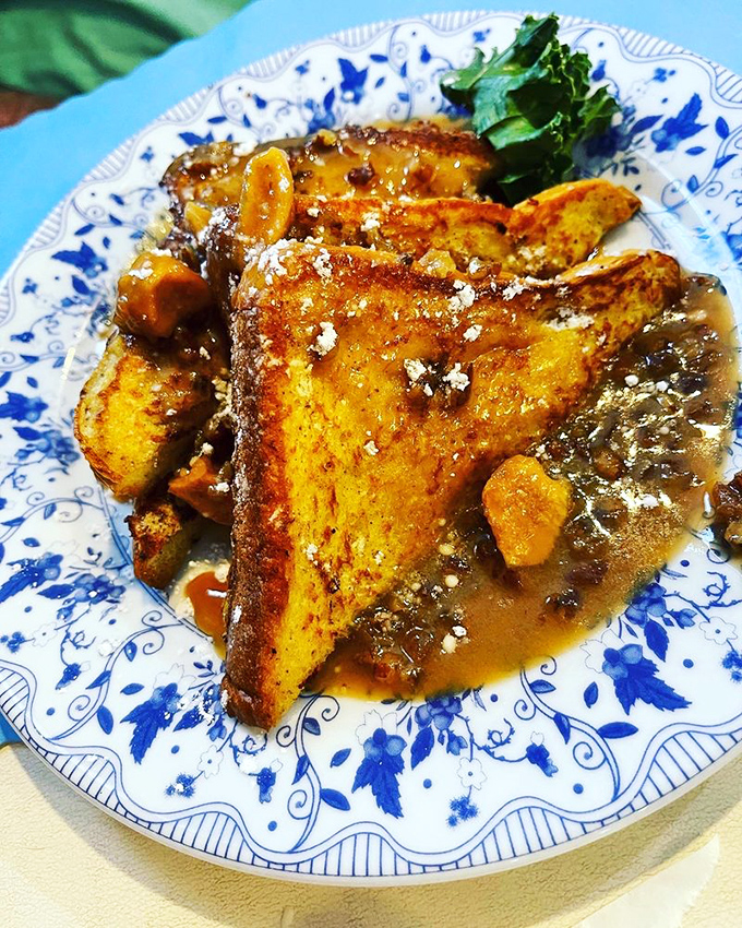 French toast that's crossed the border from breakfast into dessert territory, swimming in a cinnamon-spiced sauce that demands to be sopped up.