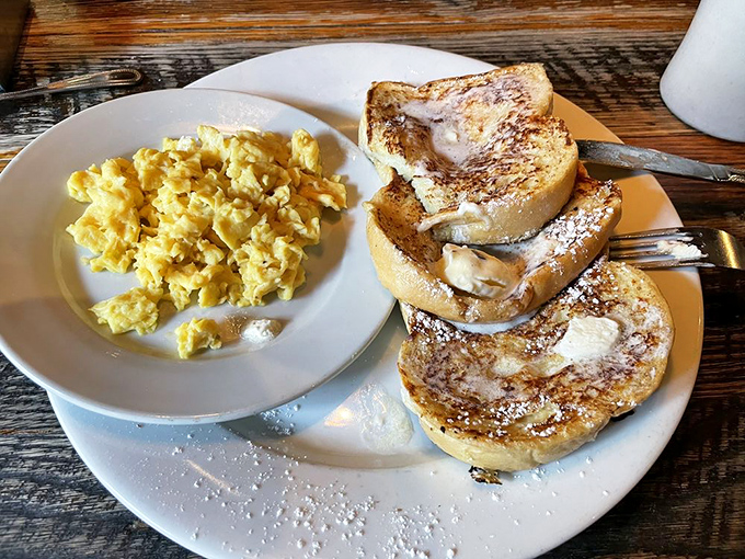 French toast that's dressed for success with powdered sugar snowfall and scrambled eggs playing the perfect supporting role.