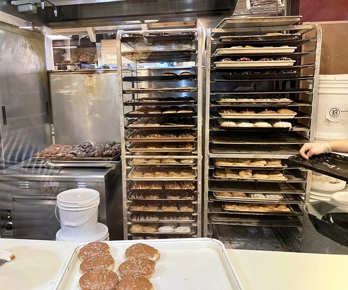 Behind the scenes magic: racks of freshly made donuts waiting their turn to make someone's day infinitely better.
