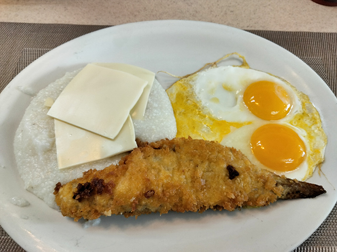 Breakfast with a coastal twist. This crispy fish alongside sunny-side-up eggs proves morning meals don't have to follow conventional rules.