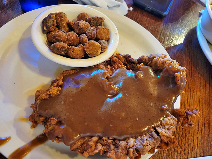 Chicken fried steak swimming in gravy with a side of fried okra. Heart doctors hate this meal, but your soul will thank you.