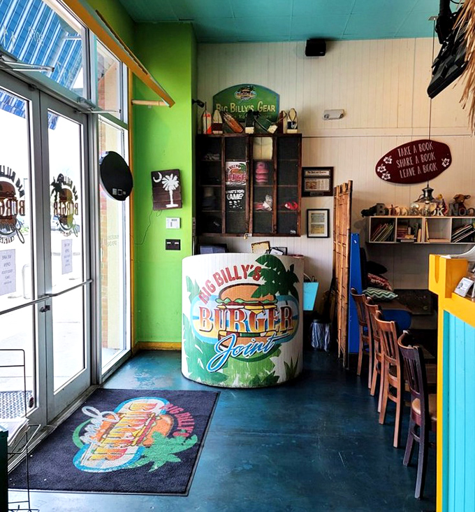 First impressions matter! The colorful entrance with its surfboard sign and book exchange corner sets the beachy tone for your burger adventure.