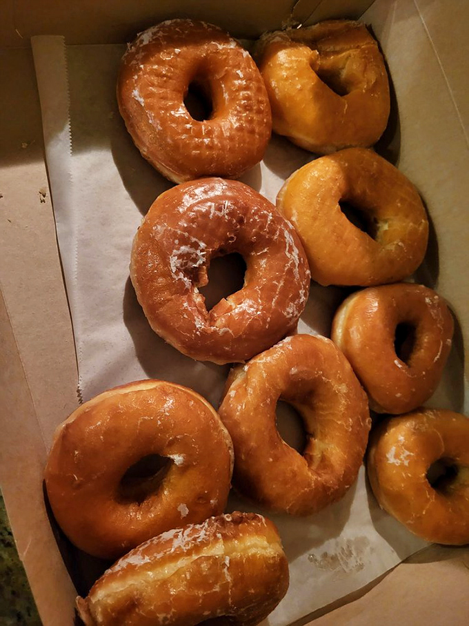 Golden glazed donuts lined up like sweet soldiers ready to conquer your morning blues completely.