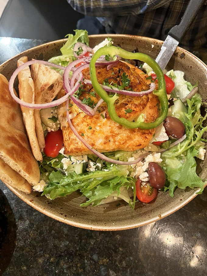 Greek salad with salmon that tastes like the Mediterranean vacation your retirement account keeps promising but hasn't delivered yet.