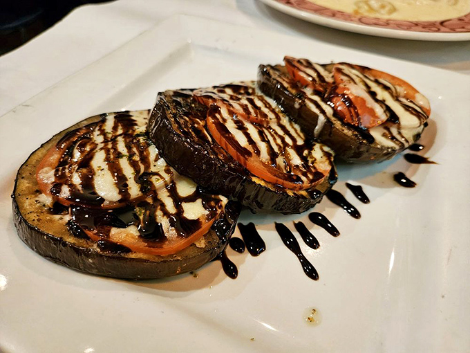 Grilled eggplant elevated to art form. These smoky, tender slices with fresh tomato and a balsamic drizzle could convert any vegetable skeptic.
