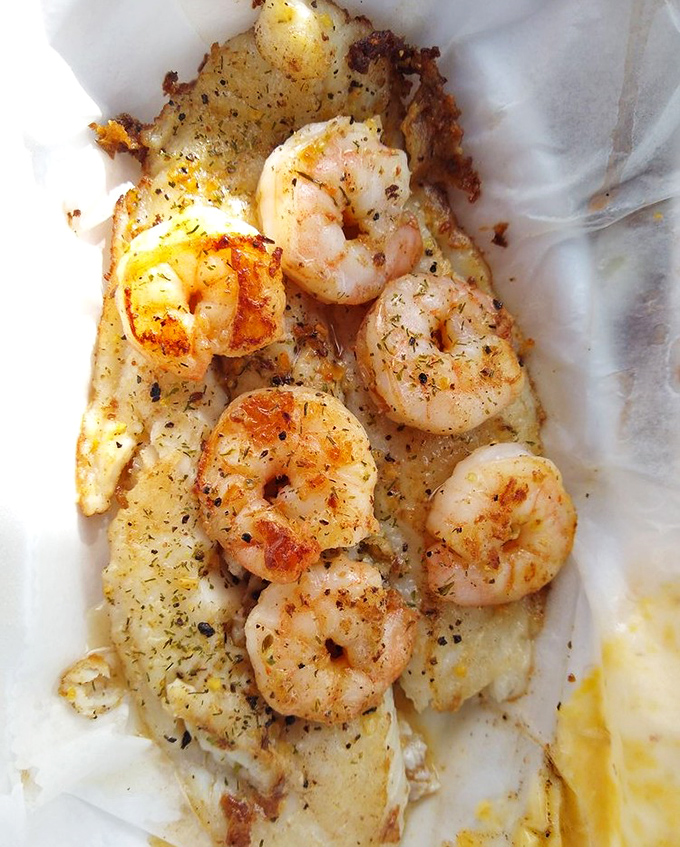 Perfectly seasoned shrimp lounging on a bed of delicate fish &ndash; the beach vacation your taste buds have been dreaming about.