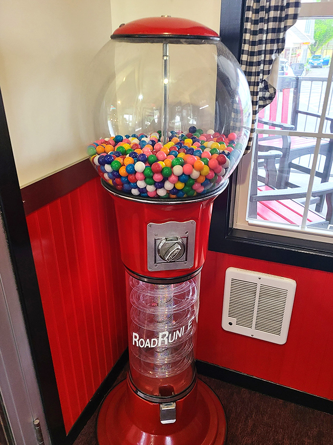 The vintage gumball machine stands sentinel, promising colorful rewards for a quarter. Childhood nostalgia in mechanical form.