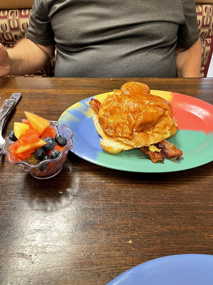 A breakfast sandwich that makes you question why you ever settled for drive-thru versions. Fresh fruit on the side pretends this is a balanced meal.