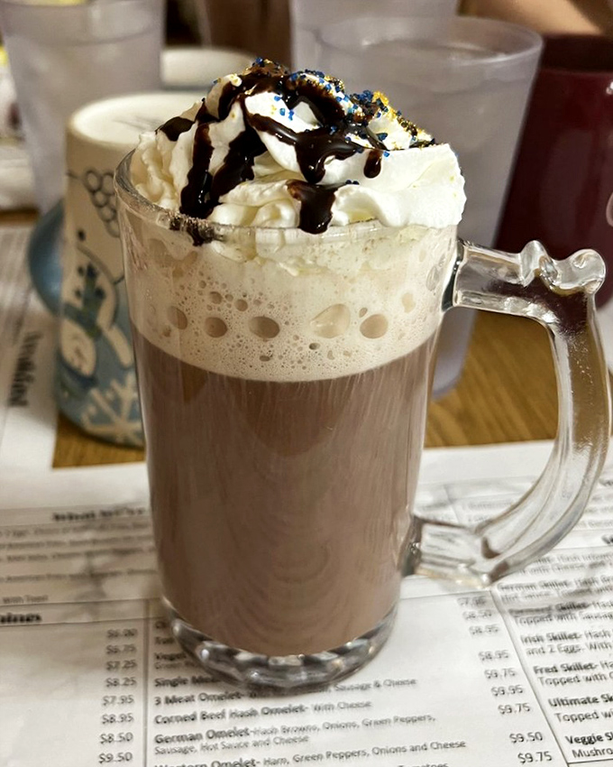 Hot chocolate with whipped cream and chocolate drizzle&mdash;because sometimes coffee needs to put on its party clothes.