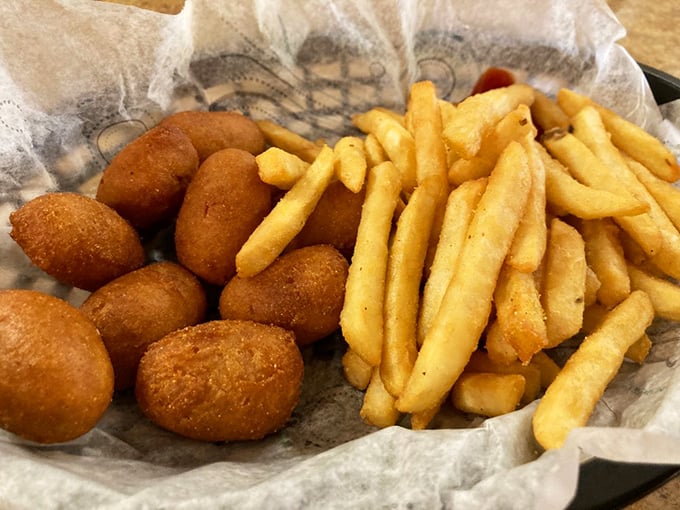 The side dish power couple: crispy hush puppies and golden fries that make you wonder why you'd ever waste stomach space on kale.