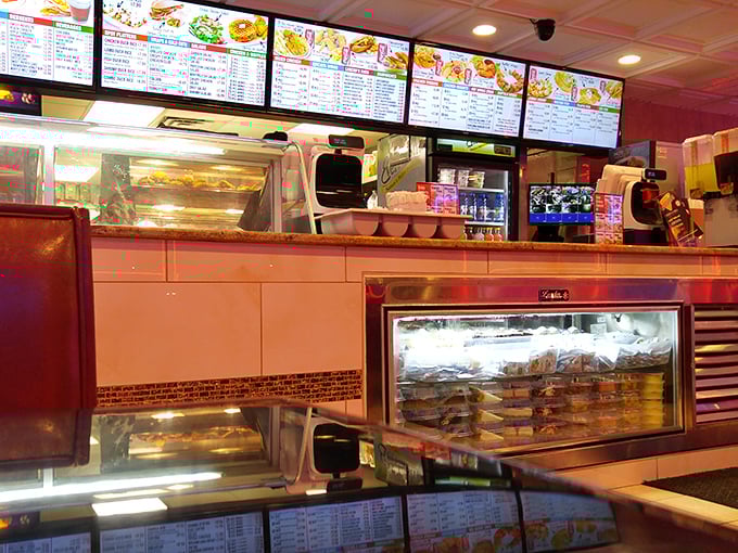 Behind the counter, where fried chicken dreams are born. That warming display is like a gallery exhibiting edible art.