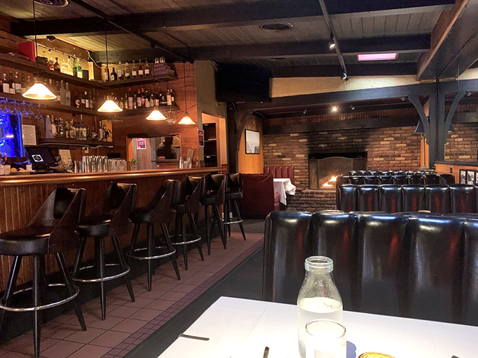 A bar area where Sinatra wouldn't feel out of place. The brick fireplace promises warmth that goes beyond the temperature.